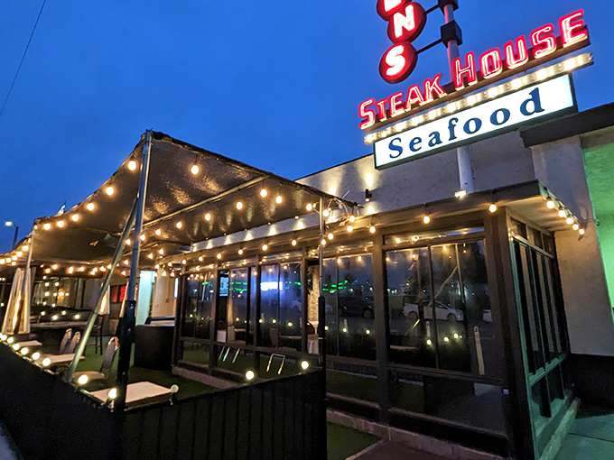 Classic steakhouse glamour meets California cool with this illuminated façade. The string lights promise magic before you even step inside.