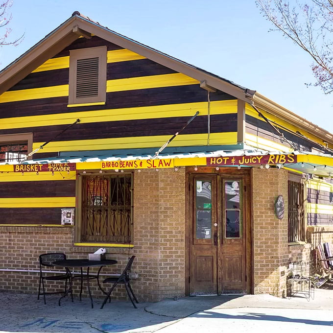 The purple and yellow stripes aren't just eye-catching—they're a barbecue bat signal calling hungry mortals to this Bywater sanctuary of smoke.