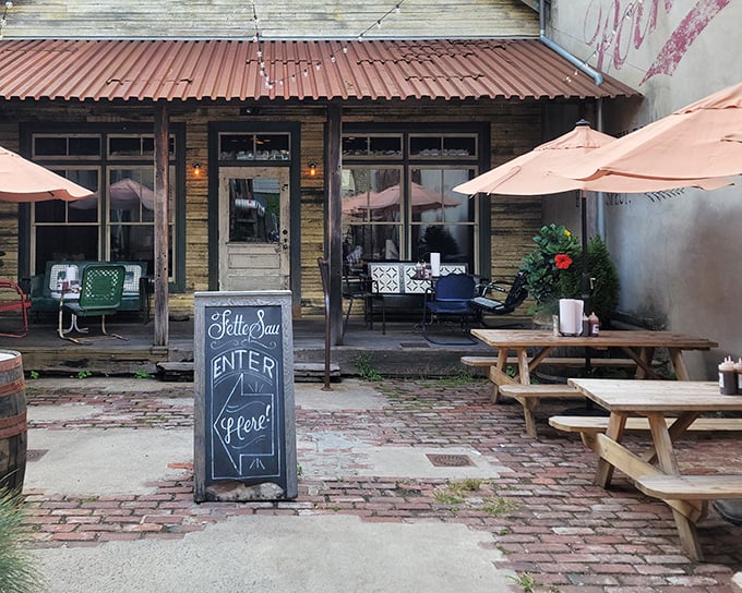 The entrance to barbecue paradise isn't pearly gates but a rustic alleyway with exposed brick and a glowing red sign that beckons hungry pilgrims.