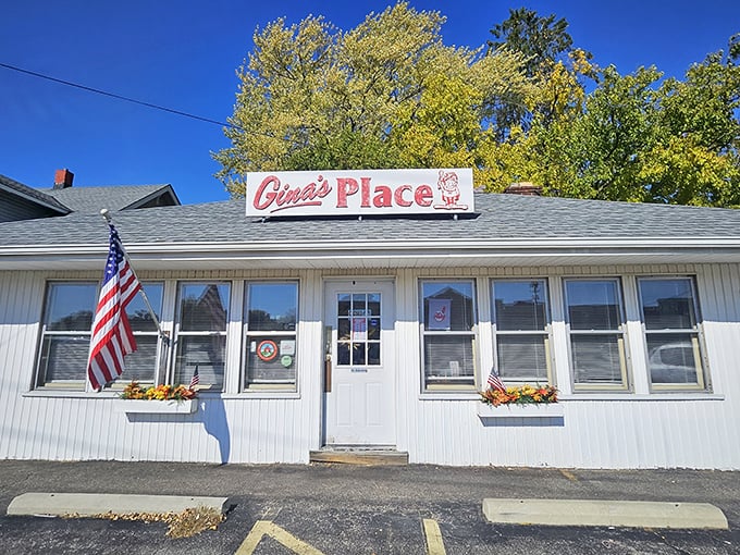 The unassuming white exterior of Gina's Place stands like a breakfast beacon in Fairview Park, complete with American flag and that classic red sign promising good things inside.