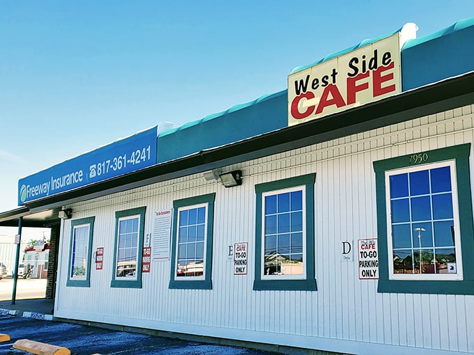 The unassuming white exterior with teal trim might not stop traffic, but trust me—culinary treasures await behind that classic "West Side CAFE" sign.