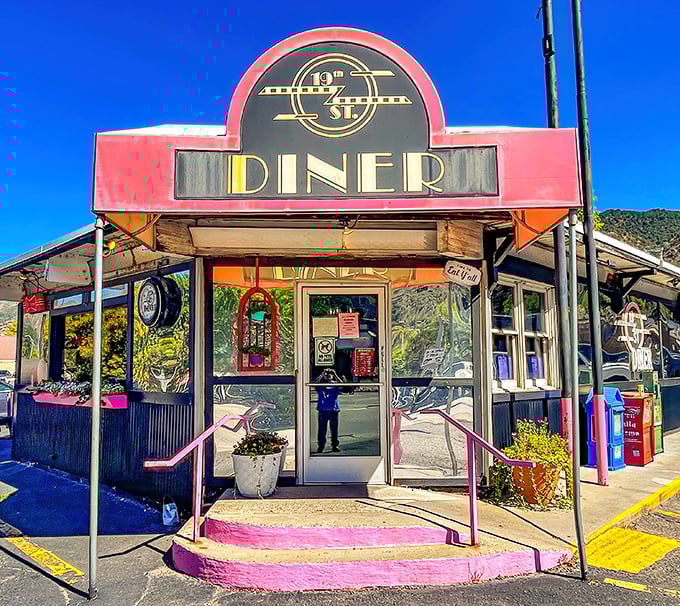 The pink-trimmed entrance of 19th Street Diner stands like a beacon of breakfast hope against New Mexico's blue sky. Resistance is futile.