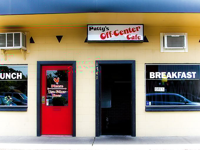 The unassuming yellow exterior with that bright red door is like a secret handshake – only the worthy know what culinary treasures await inside.