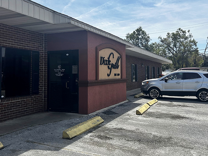 The unassuming brick exterior of Dixie Grill hides culinary treasures within. Like finding a Picasso at a yard sale, the modest façade belies the magic happening inside.