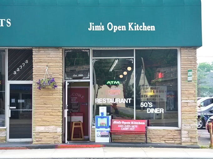The unassuming storefront of Jim's Open Kitchen beckons with its nostalgic green awning and stone facade—proof that culinary treasures often hide in plain sight.
