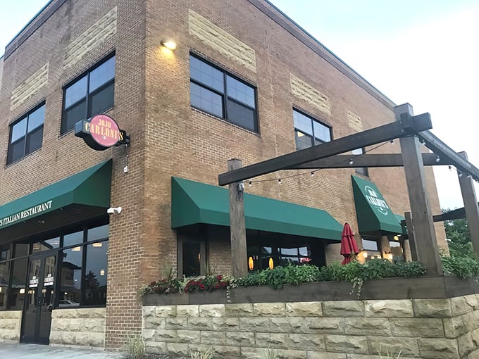 The brick exterior of Jo Jo Carloni's welcomes you with its distinctive green awnings—like an Italian grandmother beckoning you in for Sunday dinner.