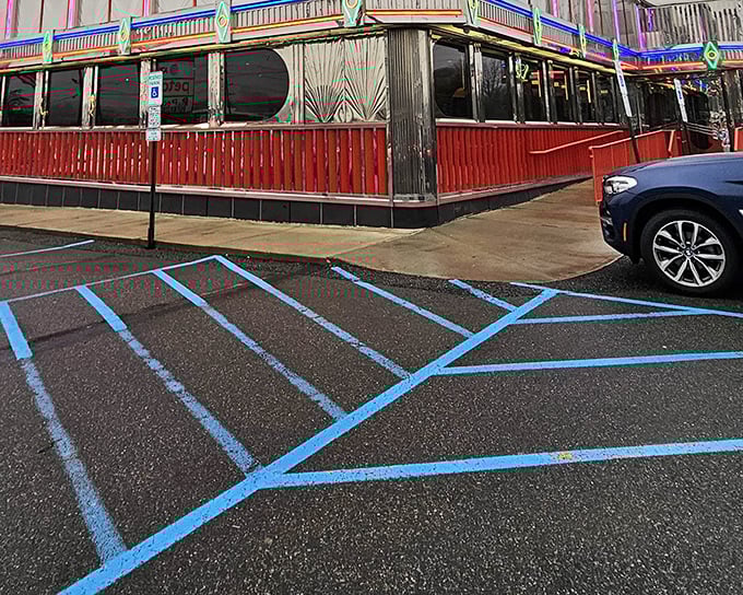 The gleaming art deco façade of Tick Tock Diner stands as a chrome-plated time machine on Route 3, beckoning hungry travelers with its unmistakable retro charm.