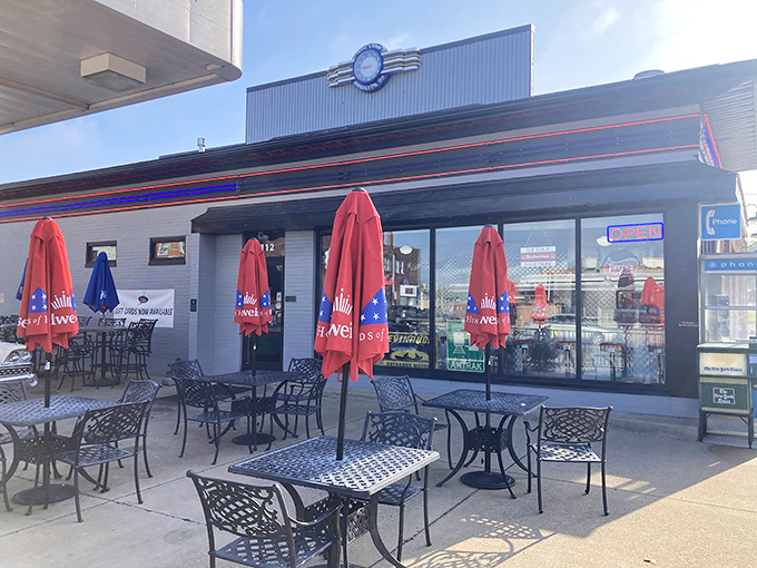 Chloe's Diner beckons with its classic Americana exterior, where red umbrellas dot the patio like cherry-topped sundaes waiting to be savored.