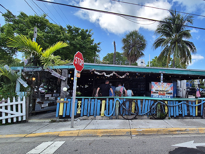 Where the sidewalk meets seafood paradise. That blue fence isn't keeping people out—it's barely containing all the flavor waiting inside.