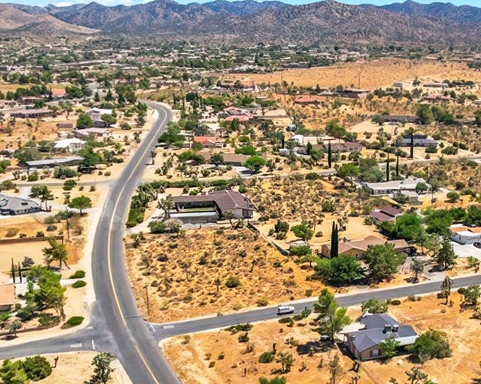 Where desert meets domesticity! Yucca Valley spreads out like a dream, with Joshua trees standing guard over neighborhoods nestled against mountains that change colors like nature's mood ring.