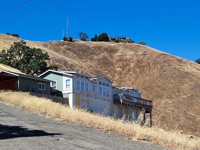 Hillside homes with a view that makes you wonder why anyone pays Bay Area prices. Golden hills cradle modest dwellings overlooking paradise.