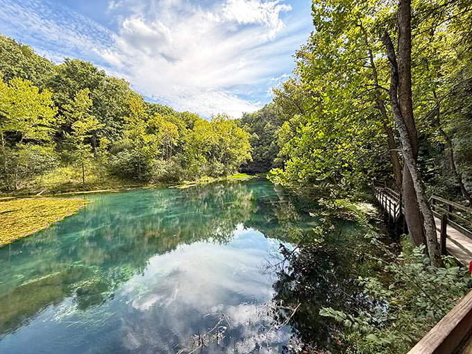 The wooden boardwalk at Ha Ha Tonka feels like nature's front porch, inviting you to sit a spell while crystal-clear waters whisper stories of the Ozarks.