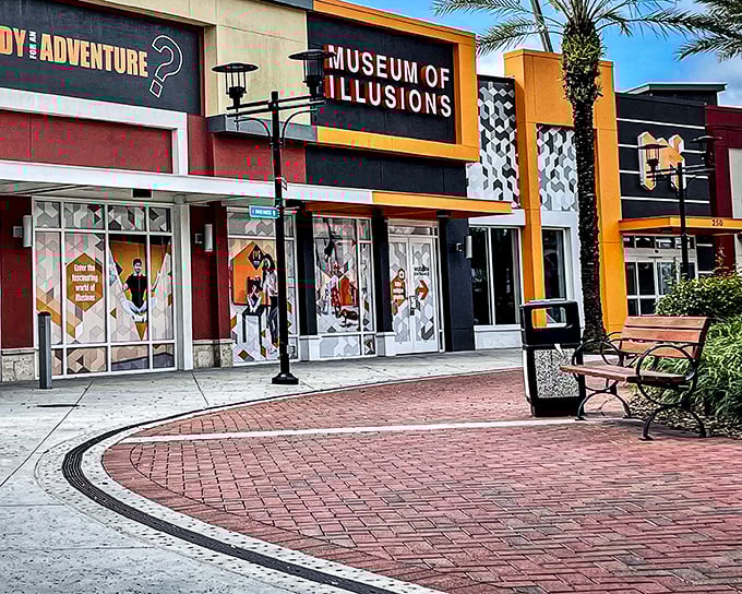 The vibrant orange and black façade of Museum of Illusions Orlando stands out at ICON Park like a magic trick waiting to happen.