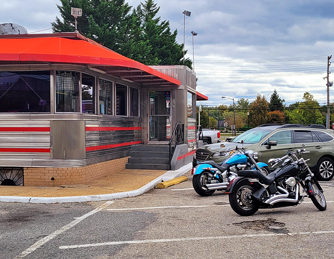 The gleaming silver-and-red exterior catches morning light like a vintage postcard come to life, its distinctive silhouette a landmark for generations of Maryland diners.