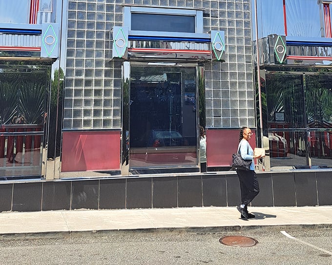 The gleaming art deco façade of Tick Tock Diner stands as a chrome-plated time machine on Route 3, beckoning hungry travelers with its unmistakable retro charm.
