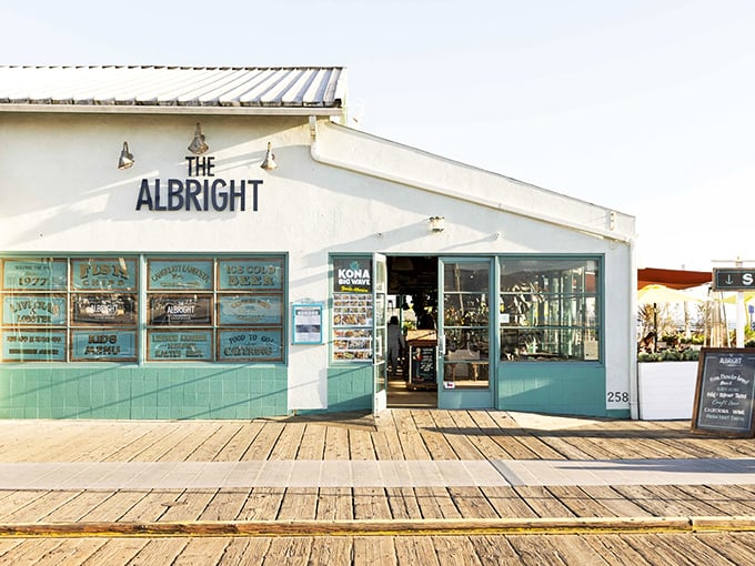 The aqua-trimmed exterior of The Albright beckons like a siren song on Santa Monica Pier, promising seafood treasures within its weathered wooden walls.