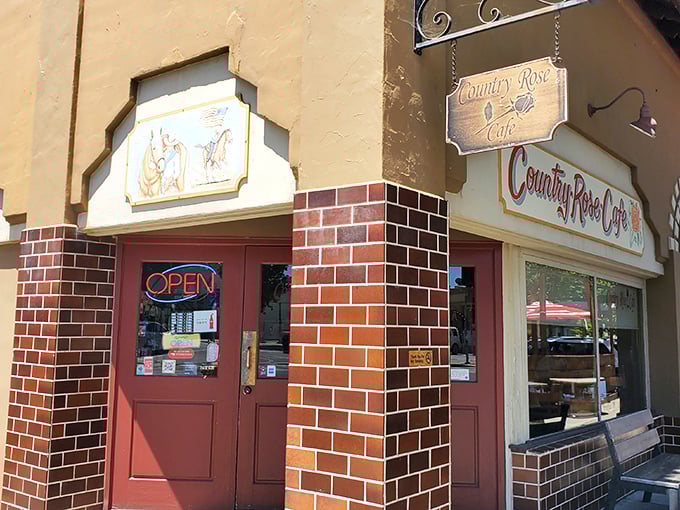 The warm brick façade and vintage signage of Country Rose Café promises comfort before you even step inside. Small-town charm with big breakfast energy.