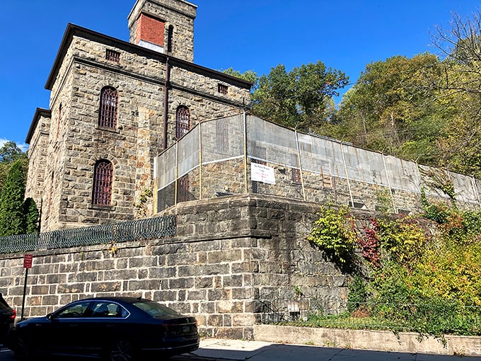 The imposing stone fortress of the Old Jail Museum stands against a blue sky, looking more like a medieval castle than a place for time-outs.