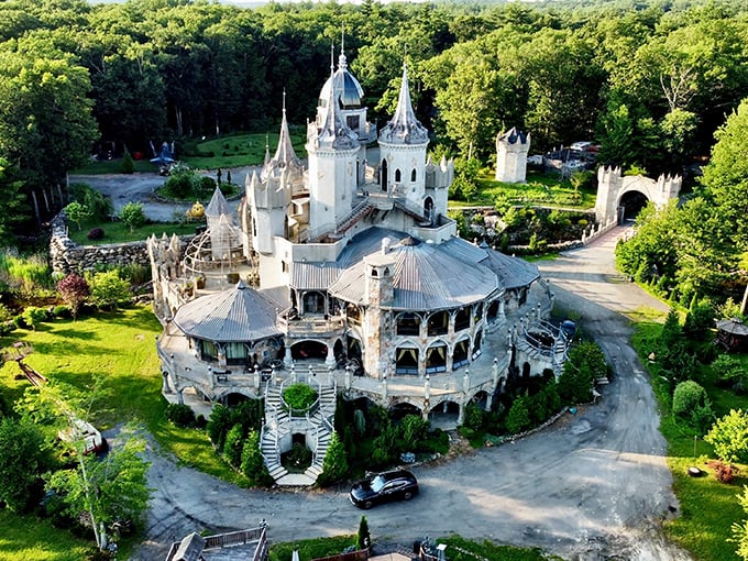 An aerial dream come true! Chris Mark Castle rises from Connecticut's woodlands like a medieval mirage, complete with turrets, spires, and that jaw-dropping circular terrace.