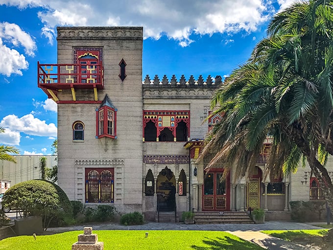 The façade of Villa Zorayda stands like a Moorish mirage in St. Augustine, its red accents popping against concrete walls that have witnessed over a century of Florida history.