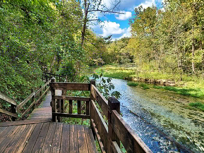 The wooden boardwalk at Ha Ha Tonka feels like nature's front porch, inviting you to sit a spell while crystal-clear waters whisper stories of the Ozarks.