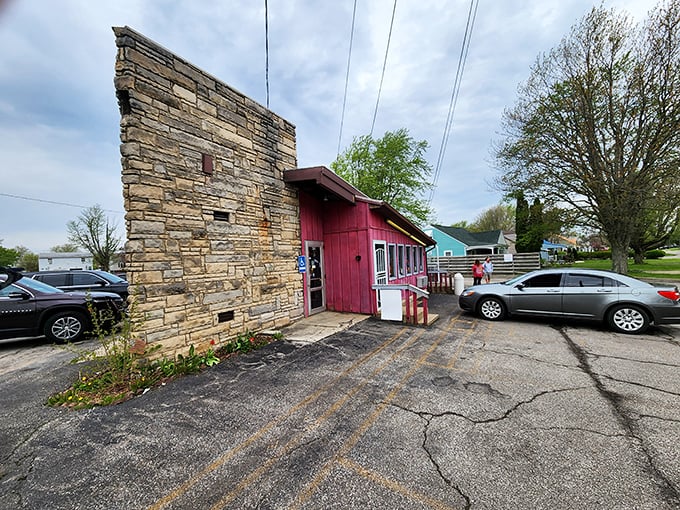 The stone-meets-crimson exterior of Porky's Drive-In stands like a culinary time capsule, promising honest food without pretension.