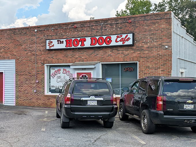 The bright red door of The Hot Dog Cafe beckons like a culinary lighthouse in Wellford, promising comfort food treasures behind that unassuming brick facade.