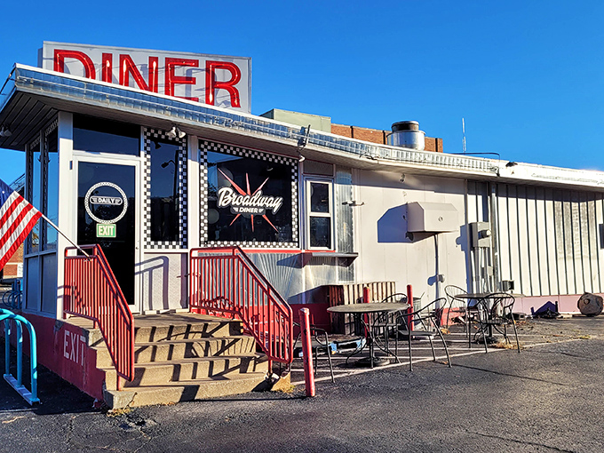 The iconic red "DINER" sign beckons hungry travelers like a lighthouse for the famished. Classic Americana at its finest.