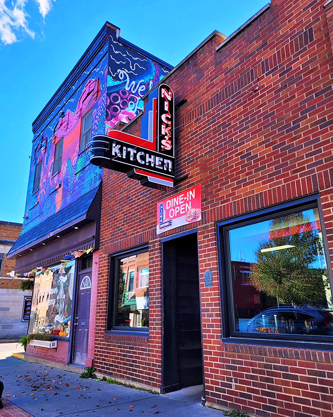 The iconic brick exterior of Nick's Kitchen stands proudly in downtown Huntington, its vintage neon sign a beacon for hungry pilgrims seeking tenderloin nirvana.