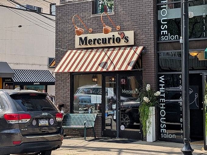 The charming storefront of Mercurio's beckons pizza pilgrims with its distinctive red and white awning—like a wink from Italy on a Pittsburgh street corner.