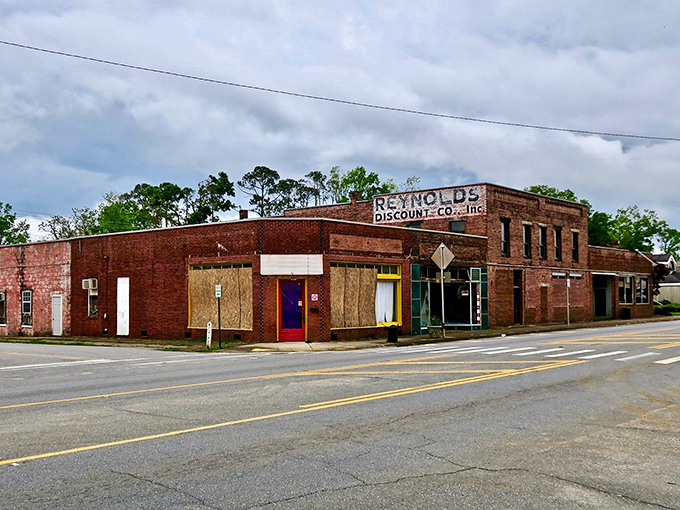 Reynolds Discount Co. stands as a brick sentinel of small-town commerce, its weathered façade telling stories of generations who've shopped its aisles.