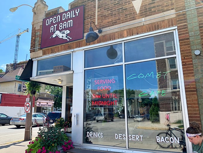 The neon glow of "SERVING FOOD UNTIL MIDNIGHT" beckons hungry souls like a lighthouse for the famished. Comet Café's storefront promises good things await inside.