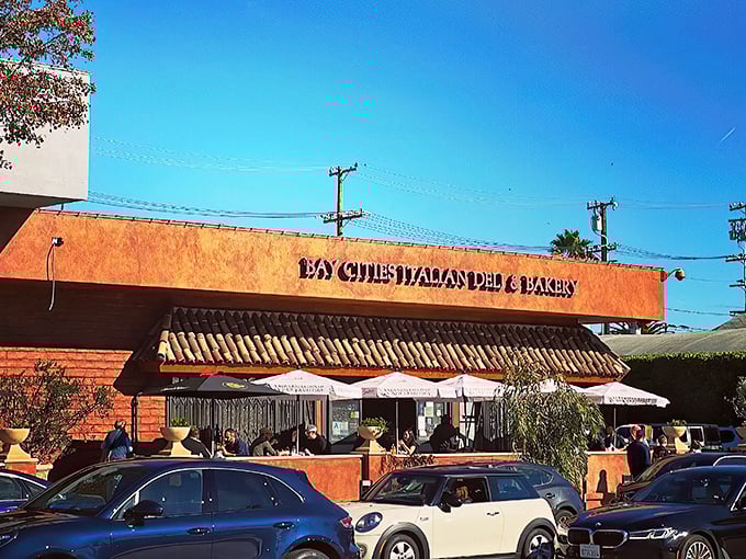 The unassuming terra-cotta exterior of Bay Cities hides culinary treasures within. Like finding a Lamborghini parked in a suburban garage—unexpected brilliance awaits.