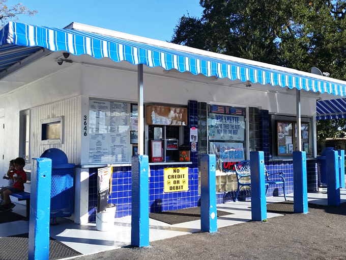 The blue posts and white building create that perfect retro vibe—like stepping into a simpler time when ice cream was life's biggest decision.