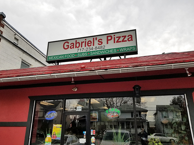 The bright red exterior of Gabriel's Pizza stands out like a culinary lighthouse on 6th Street, beckoning hungry Harrisburg locals with promises of pizza and unexpected Mexican delights.