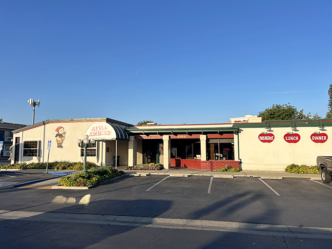 The iconic white awning of Apple Annie's welcomes hungry travelers like a culinary lighthouse in Tulare's sea of agriculture. Those vintage street lamps aren't just for show.