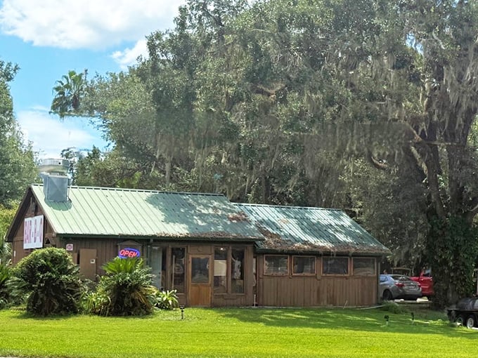 The humble green-roofed cabin beneath Spanish moss-draped oaks doesn't scream "culinary destination"—until the aroma hits you. Florida's best BBQ hides in plain sight.