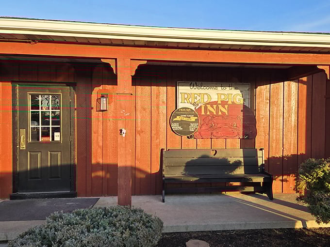 The unassuming exterior of Red Pig Inn proves once again that the best barbecue joints don't need fancy facades—just a welcoming bench and the promise of smoky delights within.