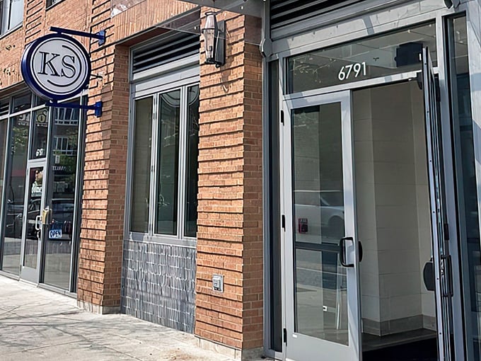 Kitchen Social's understated brick exterior with its circular "KS" sign promises culinary adventures that far exceed its modest storefront appearance.
