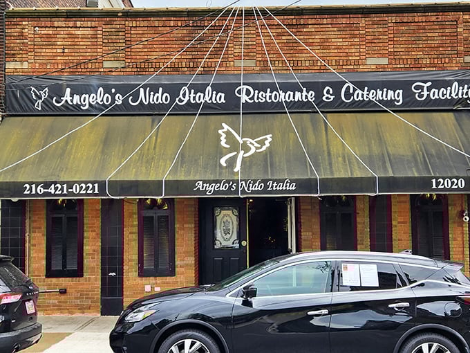 The unassuming brick exterior of Angelo's Nido Italia beckons like an old friend, promising culinary treasures behind its classic awning and modest façade.