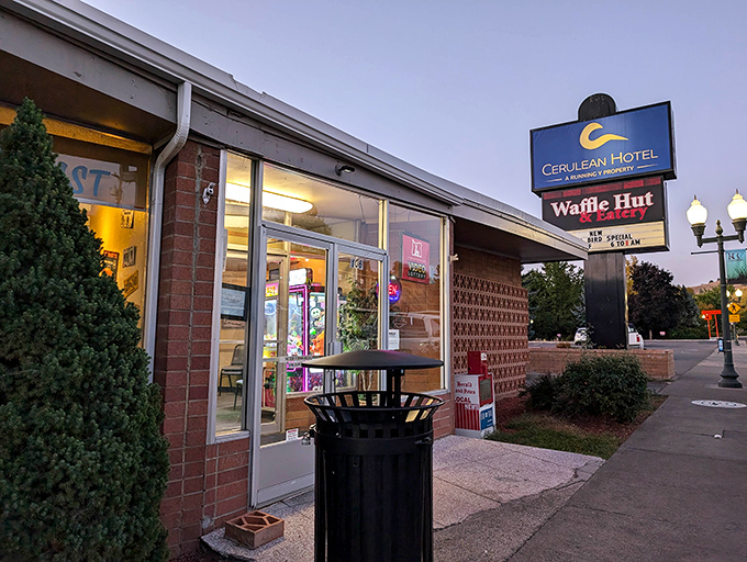 The unassuming brick exterior of Waffle Hut & Eatery proves once again that culinary treasures often hide in plain sight.