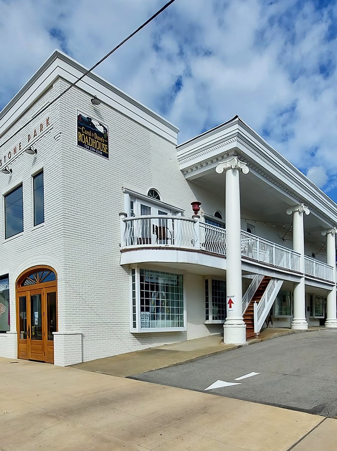 The stately white brick exterior of Carol & Dave's Roadhouse stands like a culinary lighthouse in Ligonier, beckoning hungry travelers with its classic columns and inviting balcony.