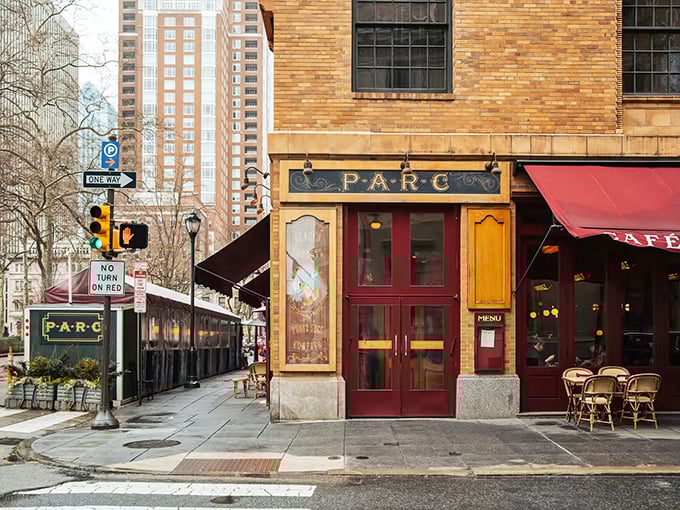 Parc's iconic corner entrance on Rittenhouse Square beckons like a Parisian postcard come to life. Those red awnings aren't just decoration—they're a promise of deliciousness within.