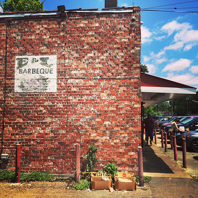 That weathered brick exterior isn't a marketing gimmick—it's a smoke-stained badge of honor earned through decades of barbecue excellence on Bailey Avenue.