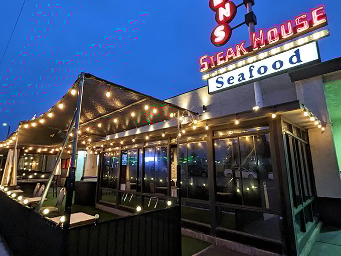 Classic steakhouse glamour meets California cool with this illuminated façade. The string lights promise magic before you even step inside.