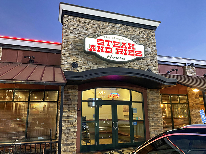 The stone facade and glowing red sign of The Original Steak & Rib House promises what every carnivore dreams of—meat prepared with respect and reverence.