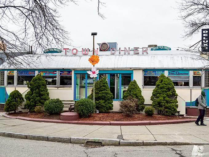 The classic stainless steel exterior of Deluxe Town Diner stands like a time capsule on Watertown's Mount Auburn Street, promising comfort food and nostalgia in equal measure.