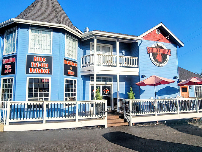 The bright blue exterior of Smokehouse 41 stands like a BBQ beacon in Oakhurst, promising smoky delights with its wrap-around porch and welcoming vibe.
