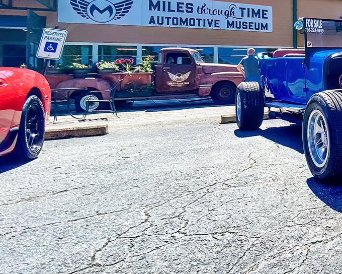 The entrance to Miles Through Time Automotive Museum beckons car enthusiasts with vintage beauties flanking the doorway—automotive appetizers before the main course inside.
