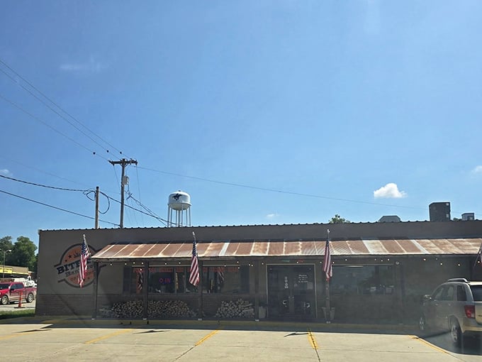 The humble exterior of Bite Me Barbecue doesn't shout for attention—it lets the smoke signals and American flags do the talking.